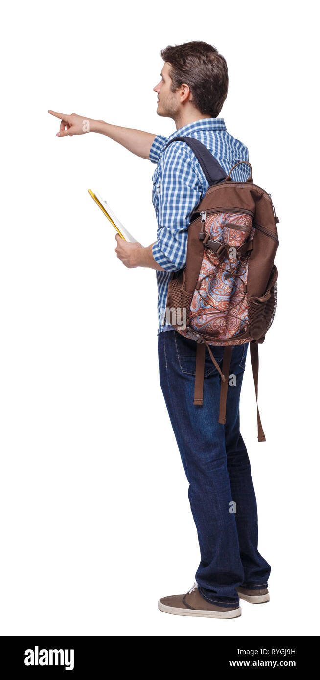 Back view of a man with backpack and textbooks points his hand upwards ...