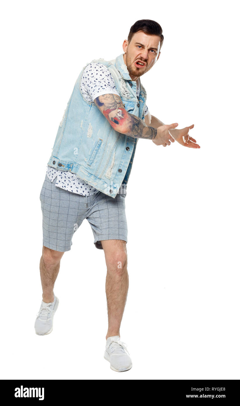 The man screams. Aggressive guy in tattoos yelling at the frame and ...