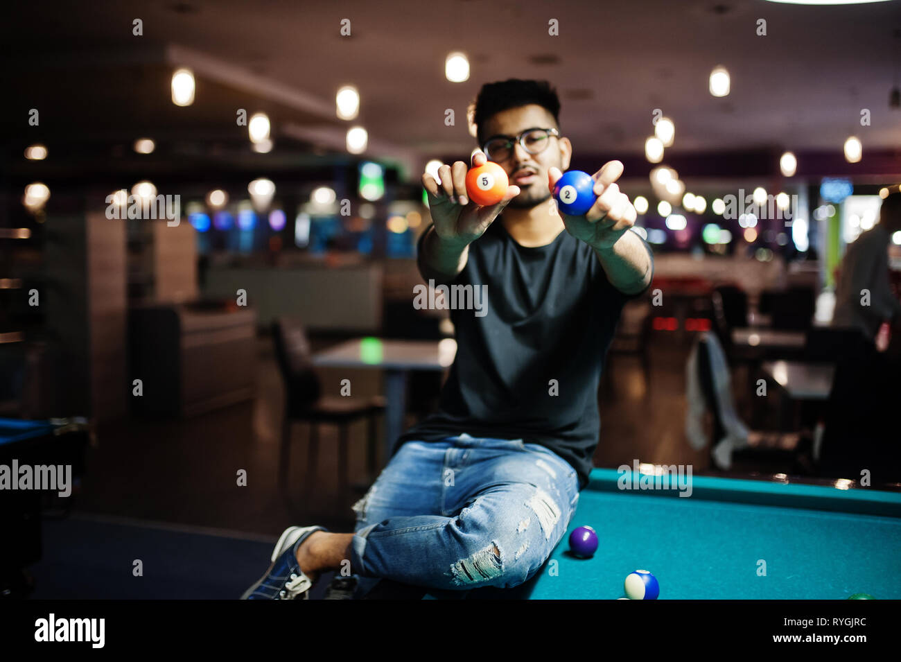 Stylish asian man hold pool billiard balls Stock Photo - Alamy