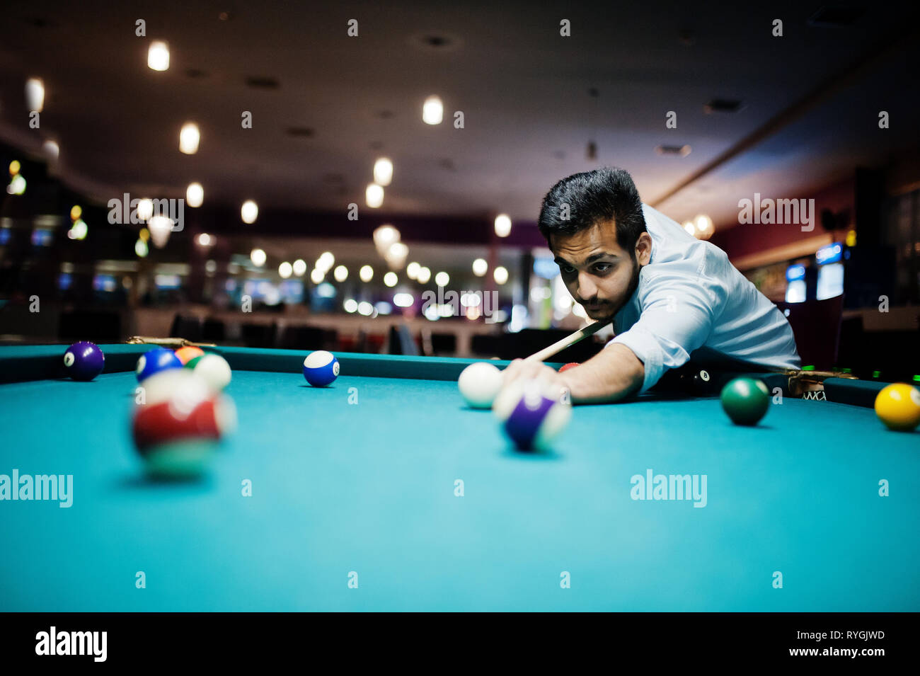 Stylish arabian man wear on jeans playing pool billiard on bar Stock ...