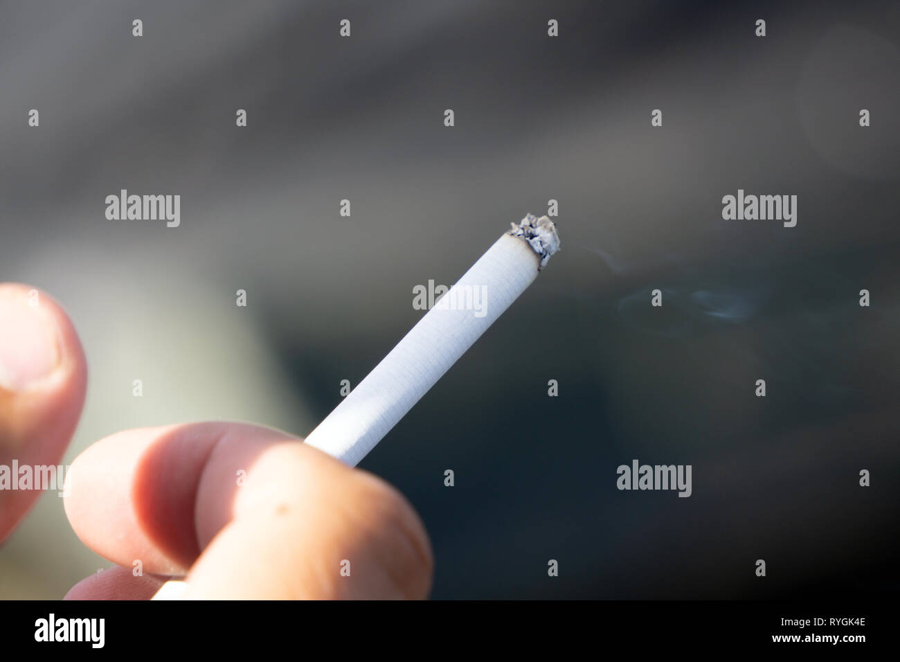 man smoking a cigarette cancer caucasian close up copy Stock Photo - Alamy