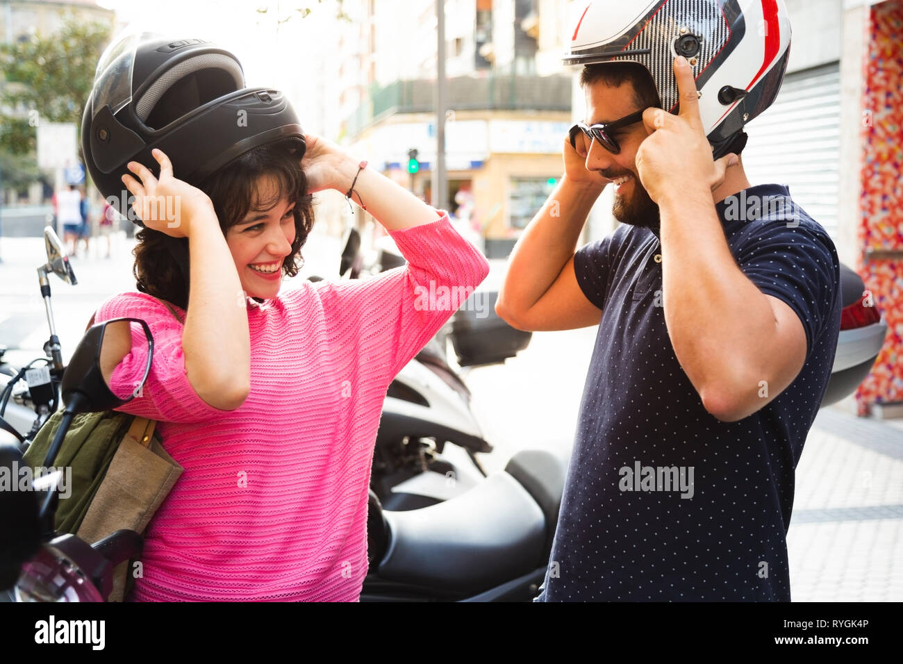 Young woman putting on helmet hi-res stock photography and images - Alamy