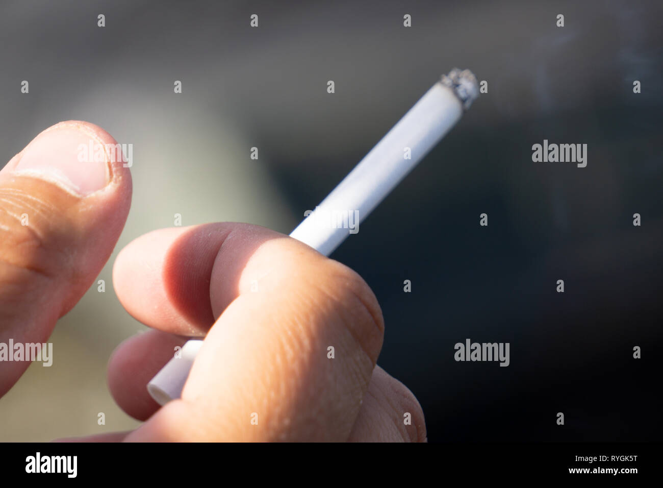 Female hand holding a cigarette. Isolated on a white background Stock ...