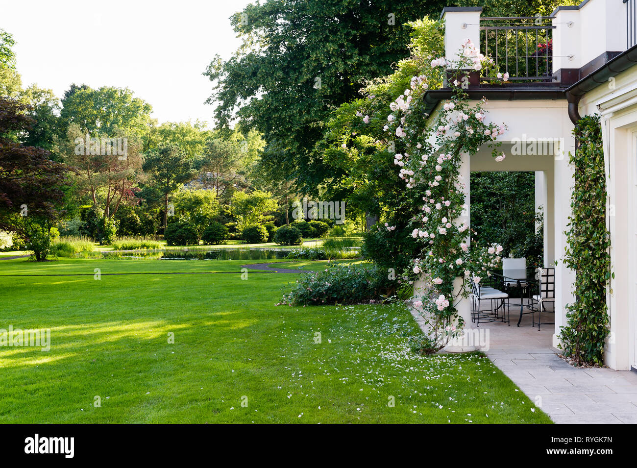 Flowers on column by lawn Stock Photo - Alamy