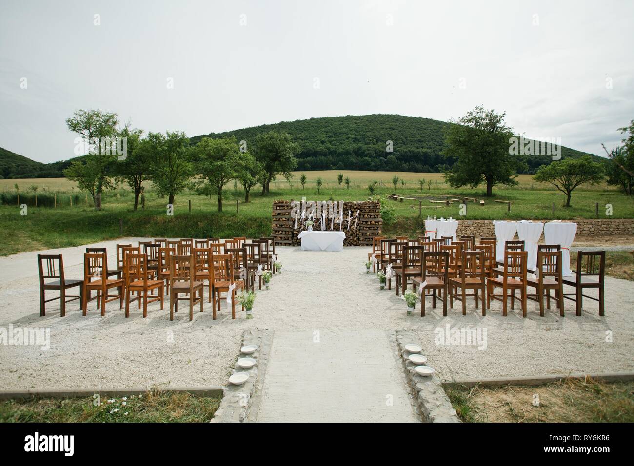 Wedding in the garden. Simply decorated location before ceremony. Quiet ...