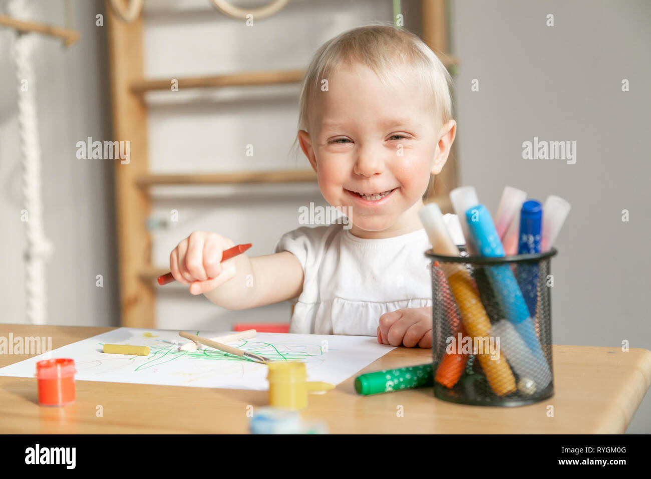 Toddler girl painting in kindergarden Stock Photo - Alamy