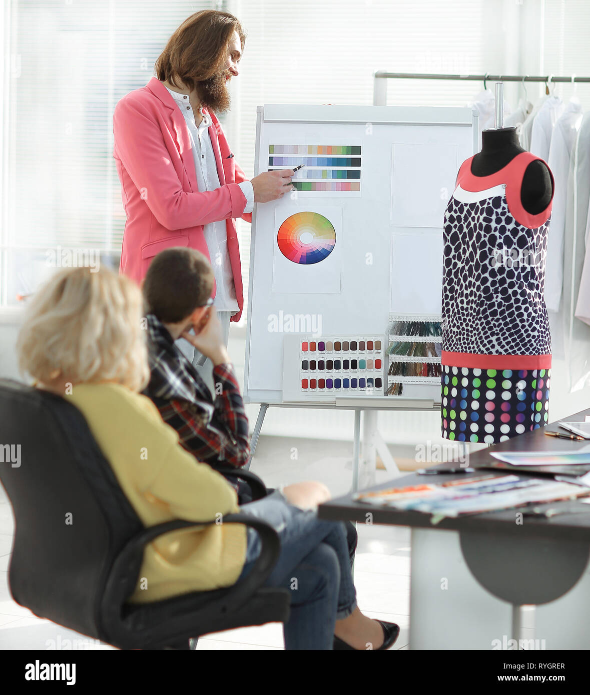 group of designers discussing the color palette Stock Photo - Alamy