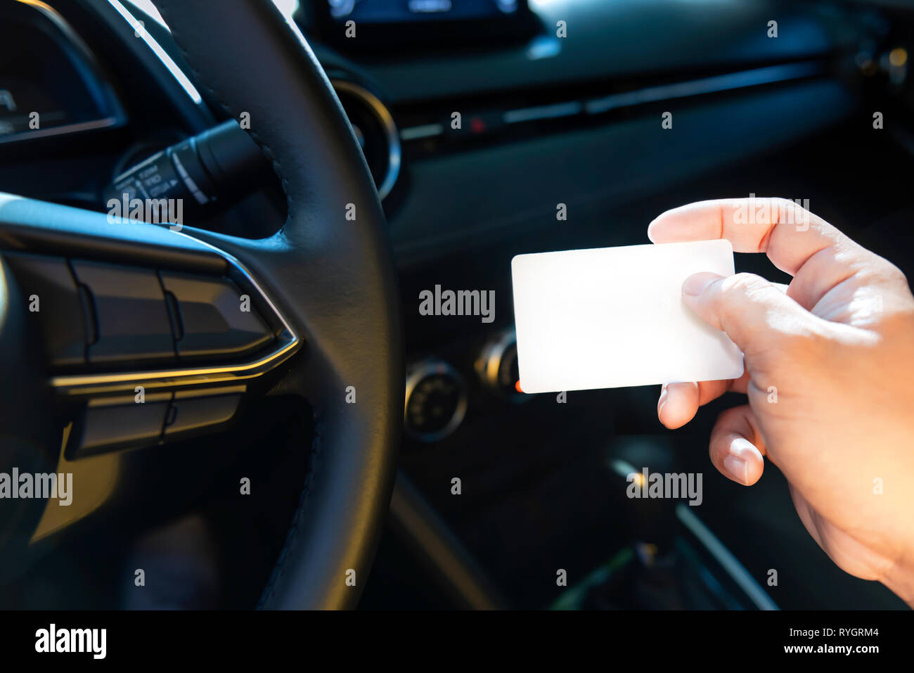 Hand holding empty license card or business card in car Stock Photo - Alamy