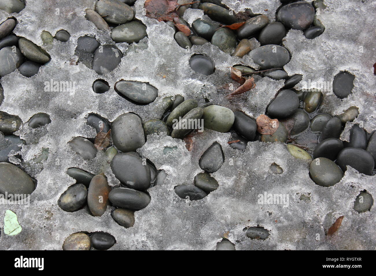 River rocks frozen in ice create a zen and and Feng shui effect Stock ...