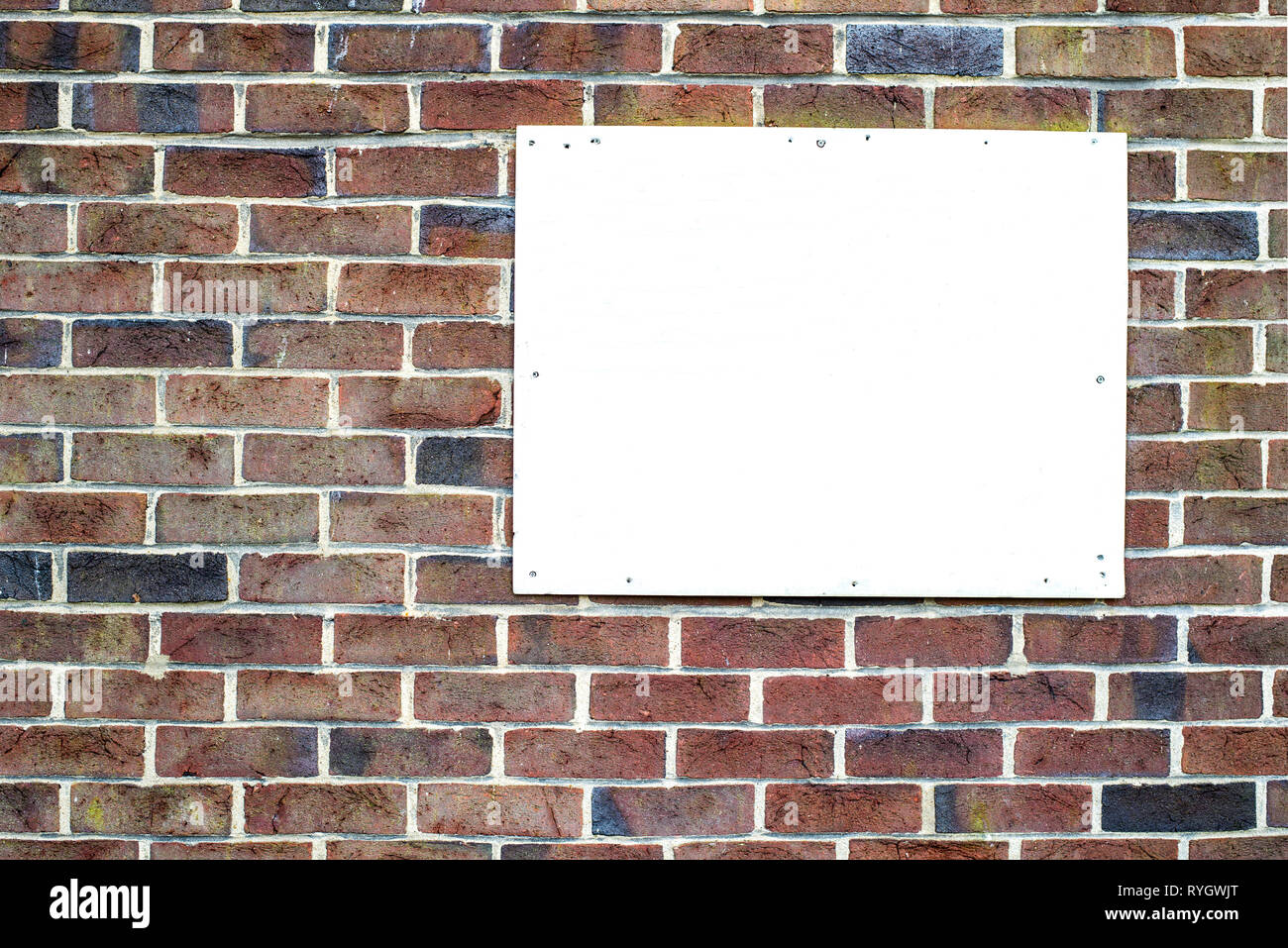 Brick wall with white empty sign to be filled with bespoke text or ...