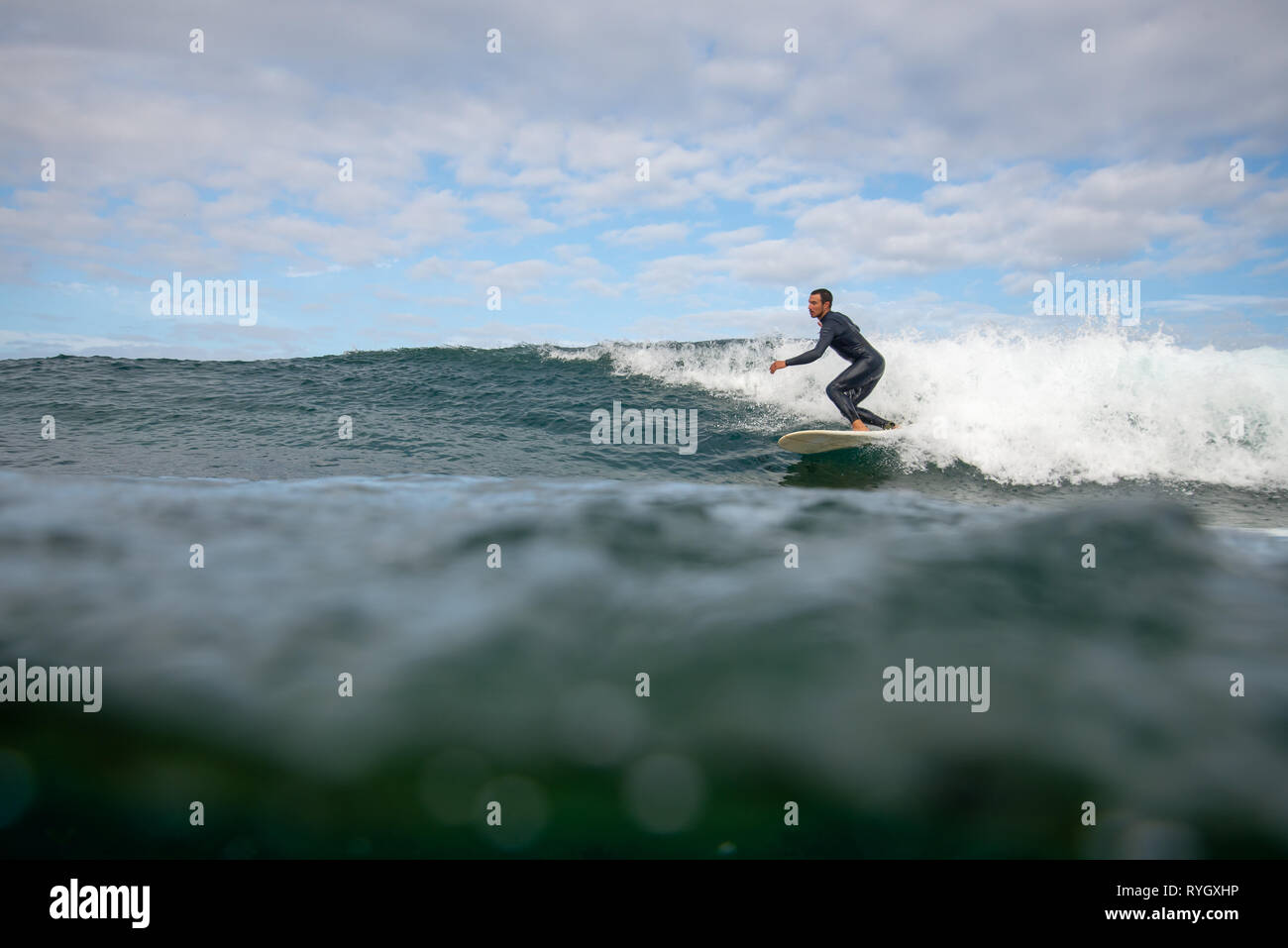 surfer riding waves on the island of fuerteventura in the Atlantic ...