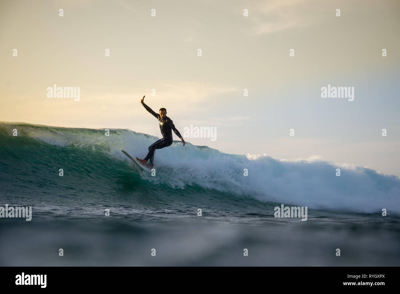 surfer riding waves on the island of fuerteventura in the Atlantic ...
