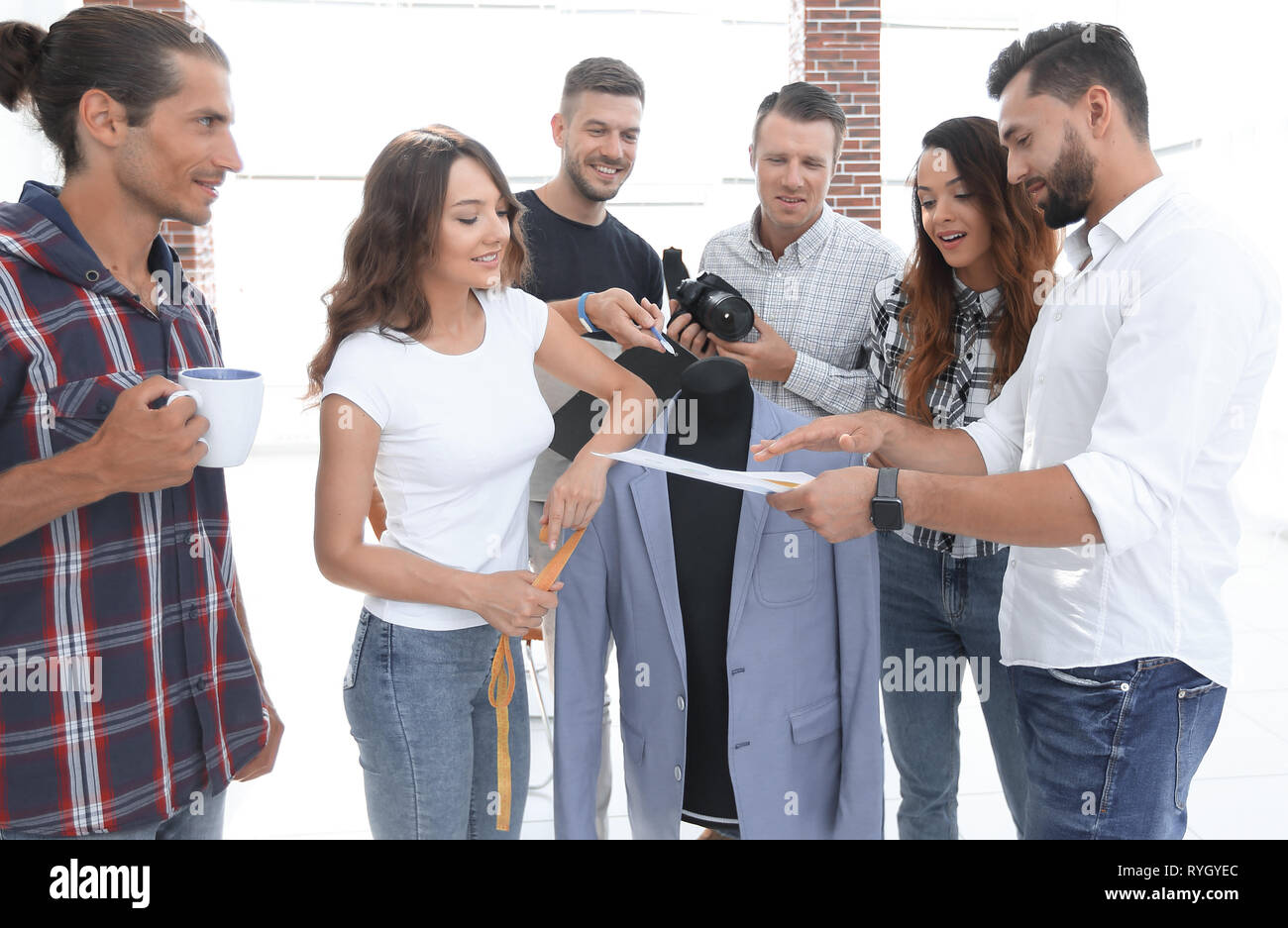 designers working with new models of men's clothing Stock Photo - Alamy