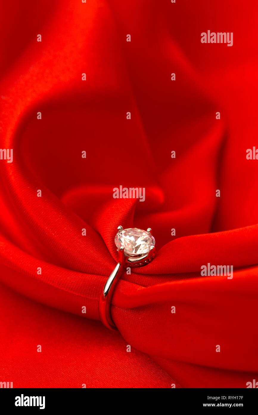 Red silk and a diamond ring Stock Photo - Alamy