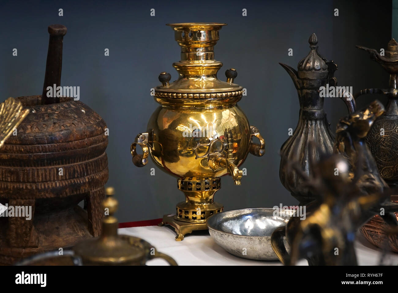 Golden colored samovar and copper enamels are in an antique bazaar ...