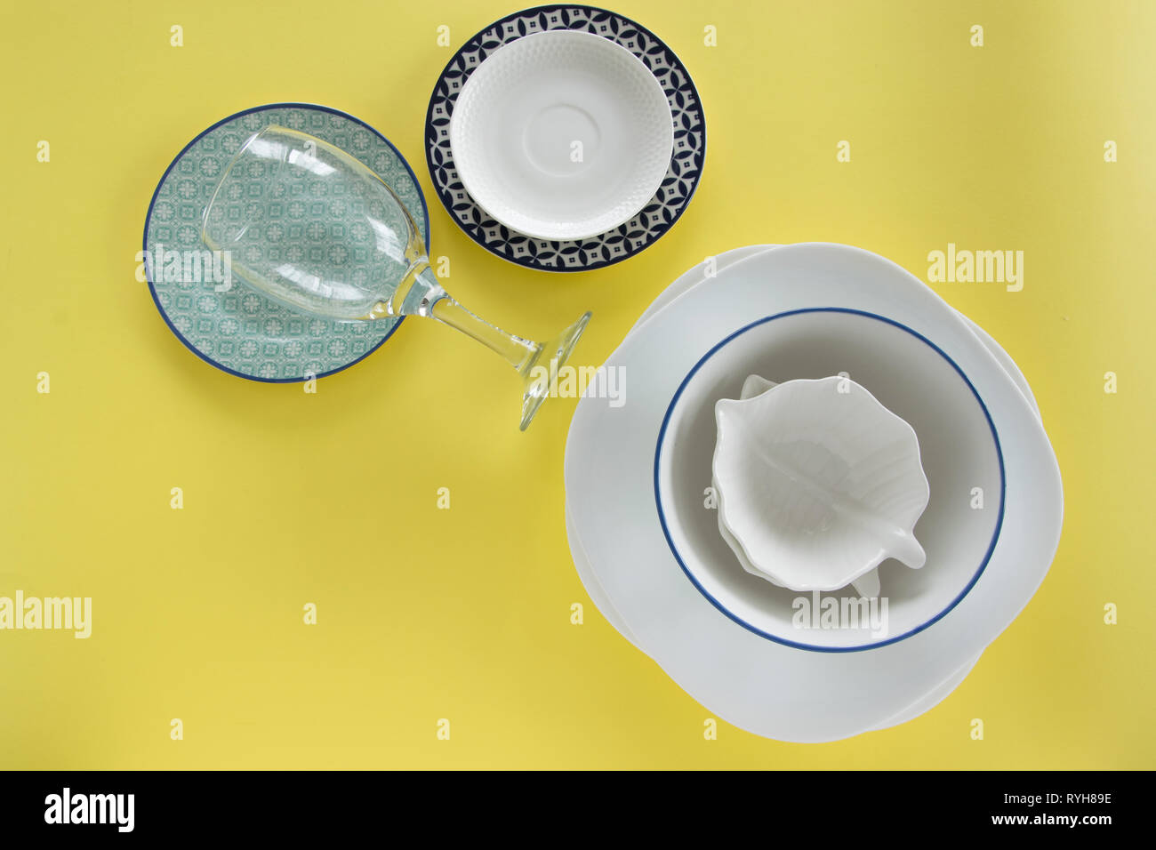 Different porcelain tableware on fresh yellow background Stock Photo ...