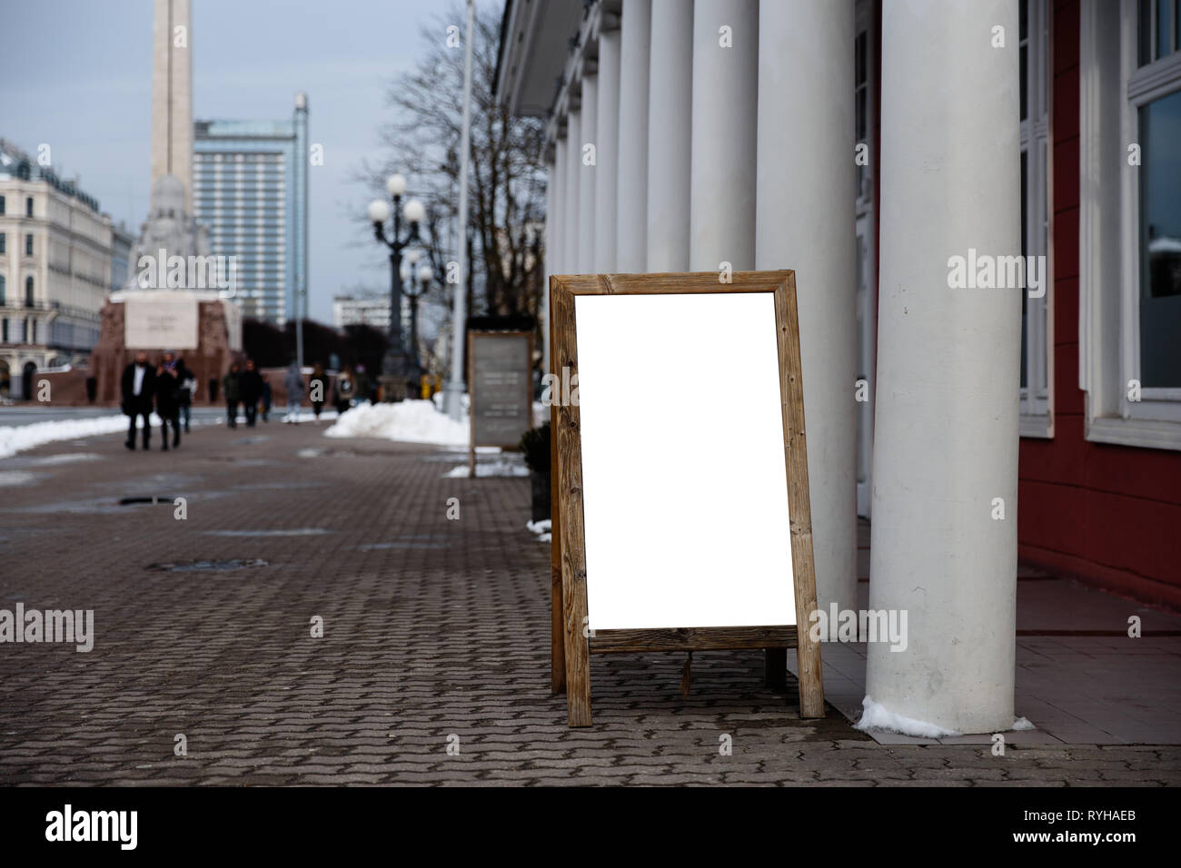 Blank ad space on a wooden stand in the street outside Stock Photo - Alamy