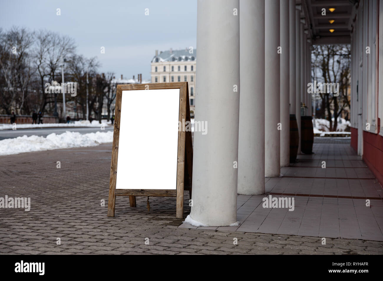 Blank ad space on a wooden stand in the street outside Stock Photo - Alamy