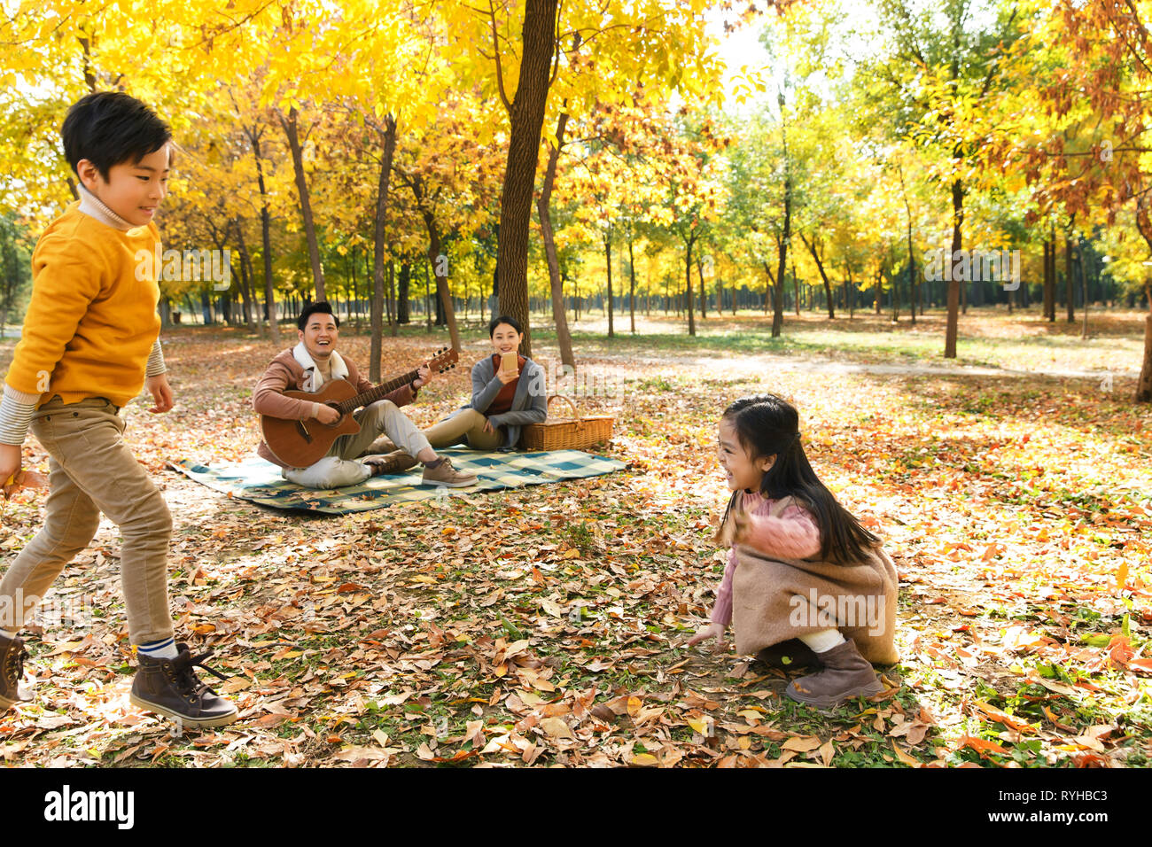 Happy families play outdoors Stock Photo - Alamy
