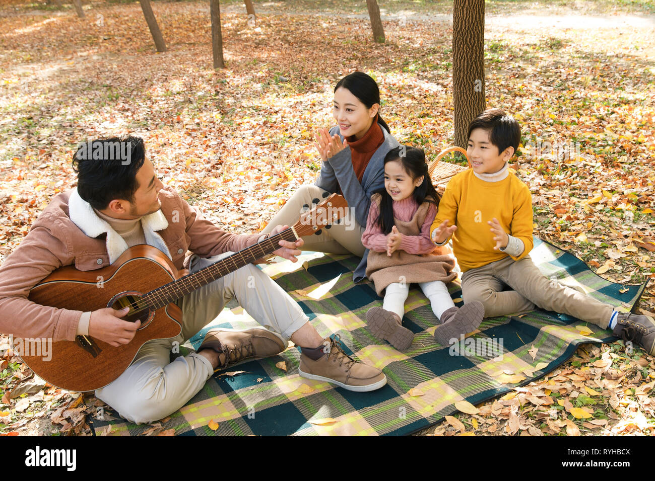 Happy families play outdoors Stock Photo - Alamy