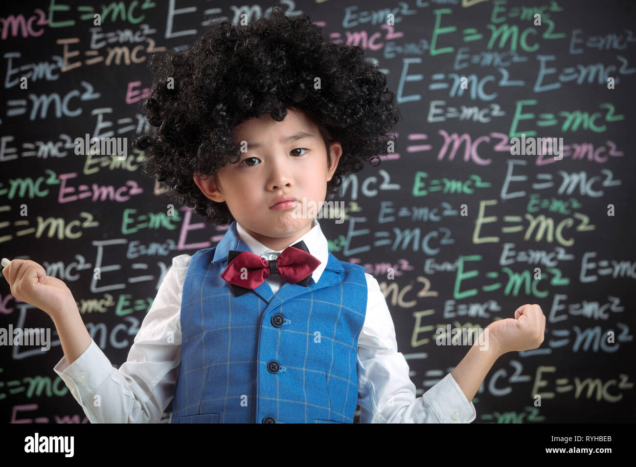 Primary school boy standing in front of the blackboard Stock Photo - Alamy