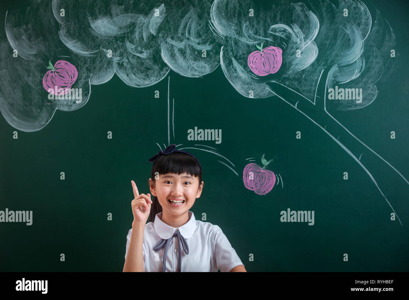 Primary school girls in front of the blackboard Stock Photo - Alamy