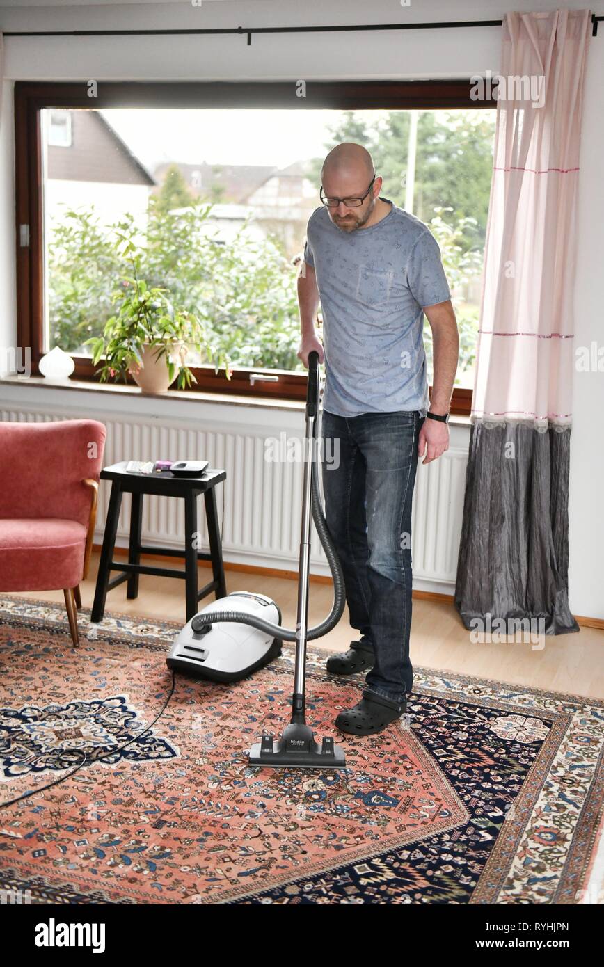 Bad Grund, Germany. 09th Mar, 2019. A man is doing household chore ...