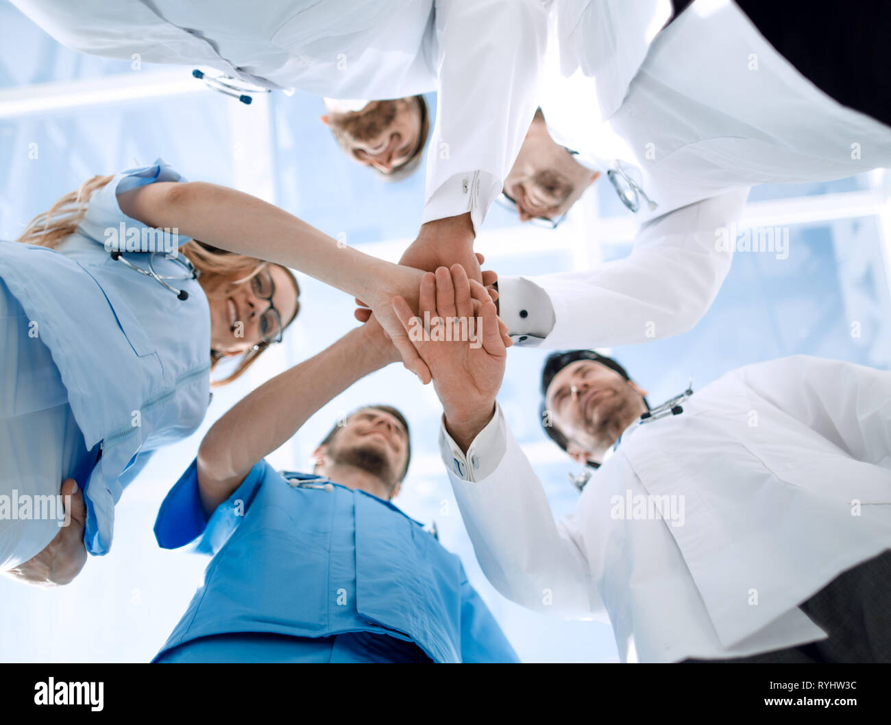 Health care workers demonstrating unity, bottom view Stock Photo - Alamy