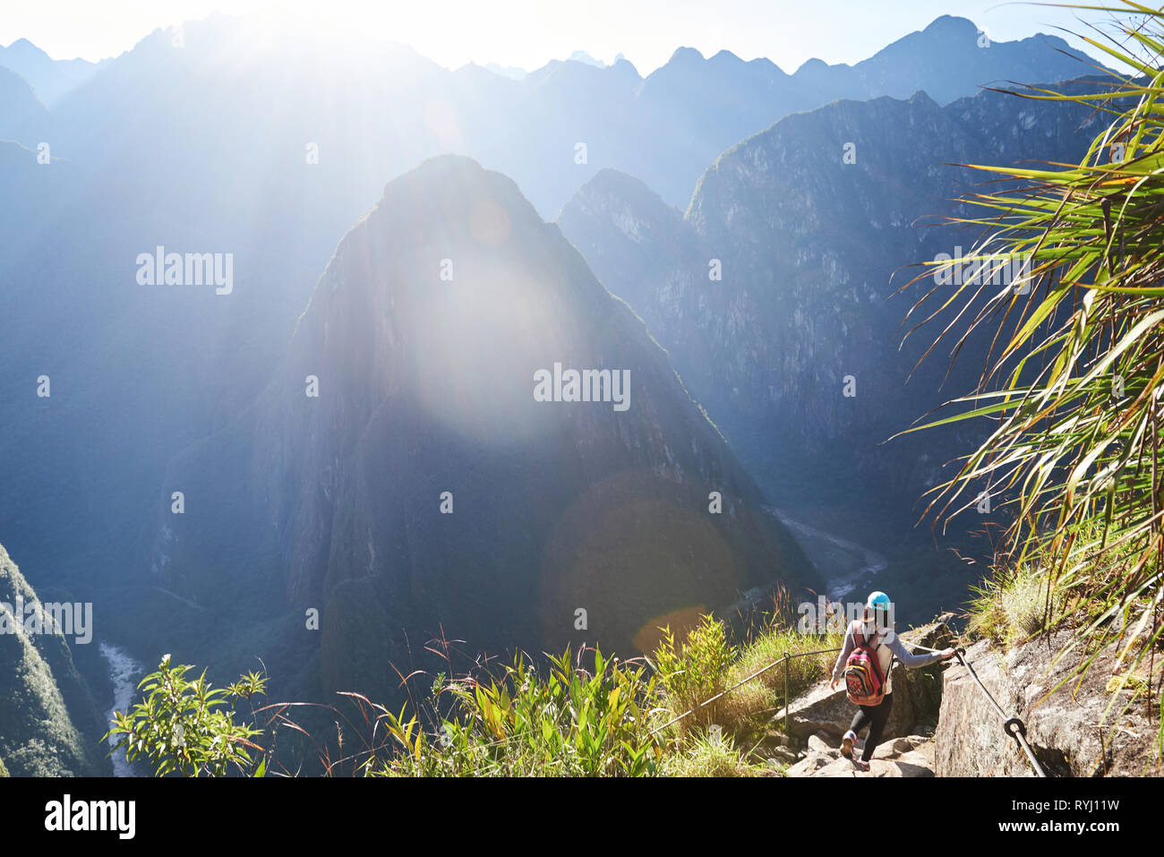 Woman walking down from hiking path on mountain Stock Photo - Alamy
