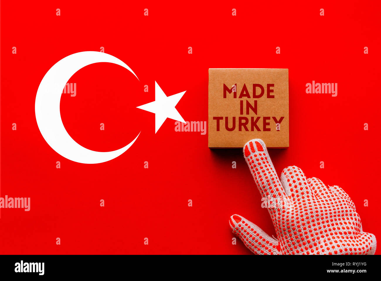 Made in Turkey, worker with protective gloves holding cardboard product ...