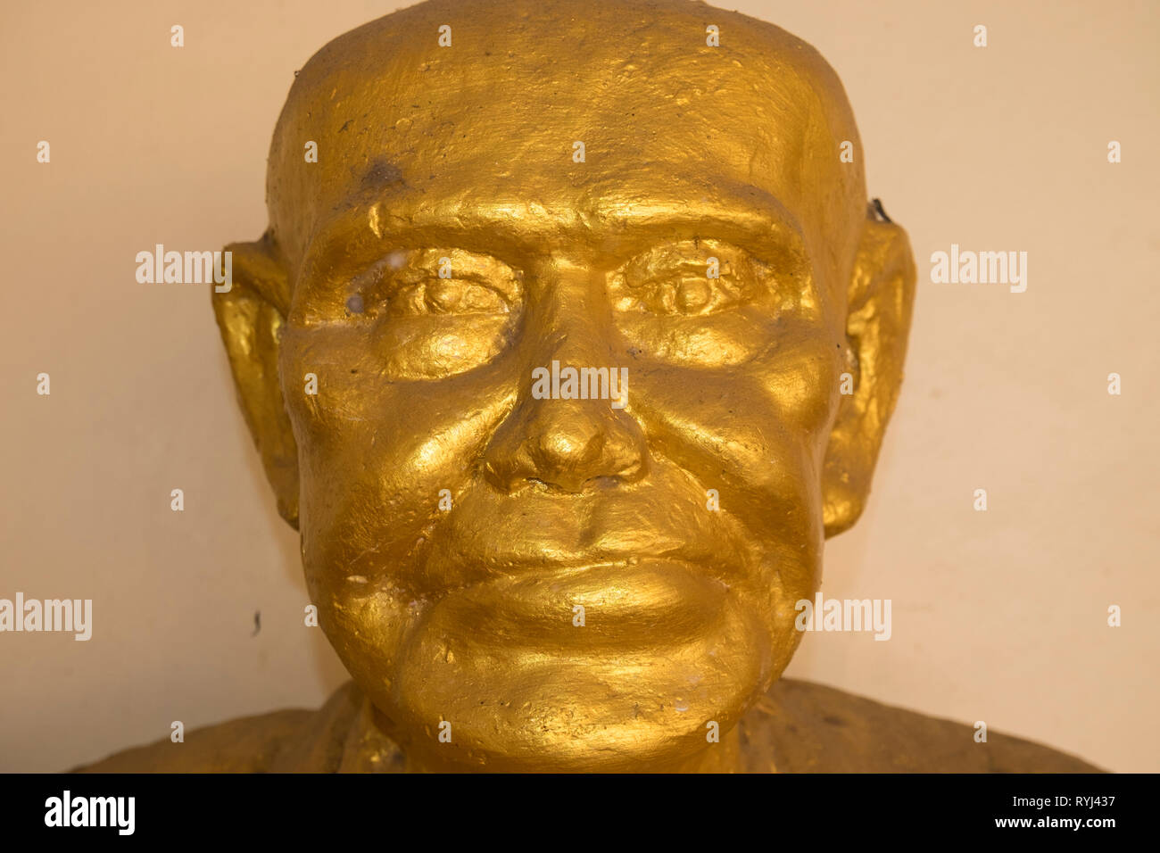 A closeup of a gold monk bust at Wat Klang in Khon Kaen, Thailand Stock ...