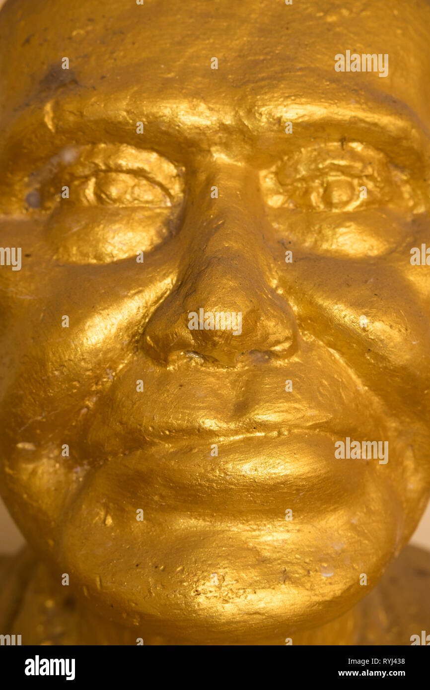 A closeup of a gold monk bust at Wat Klang in Khon Kaen, Thailand Stock ...