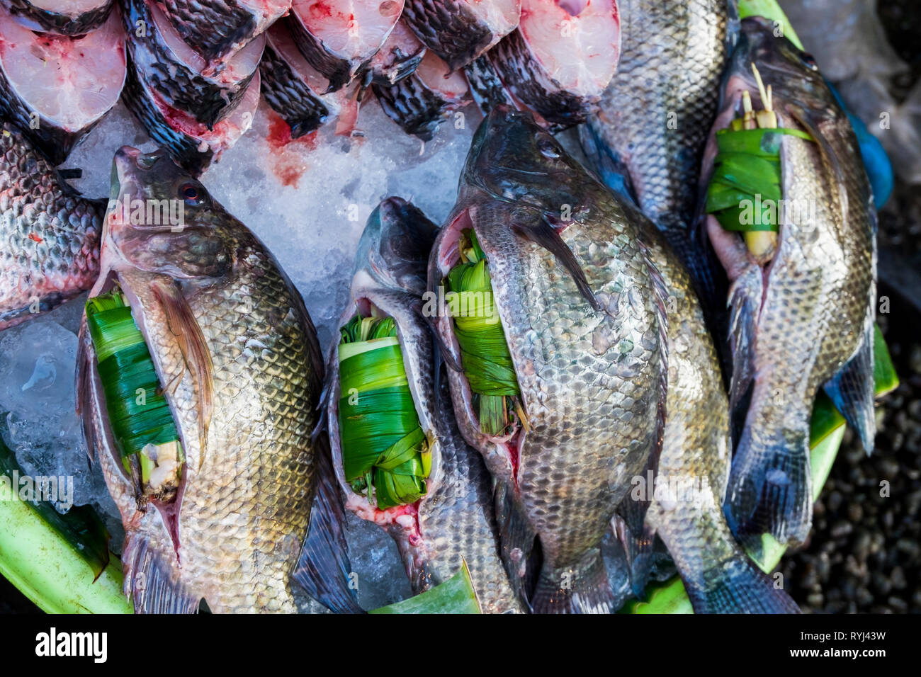Fresh fish, gutted and stuffed, is for sale at a fresh market in Khon ...