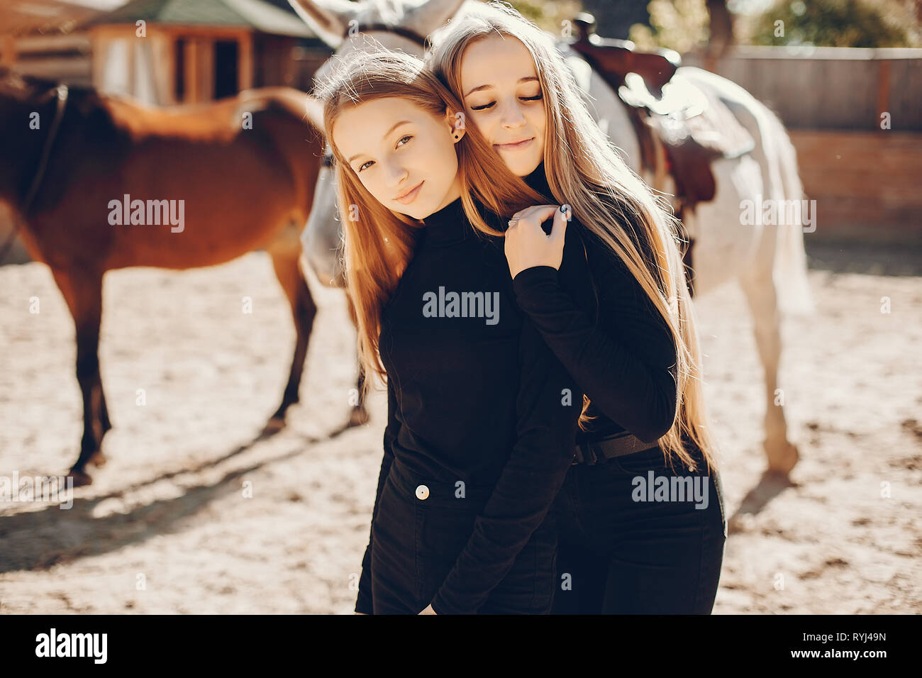Elegant girls with a horse in a ranch Stock Photo - Alamy