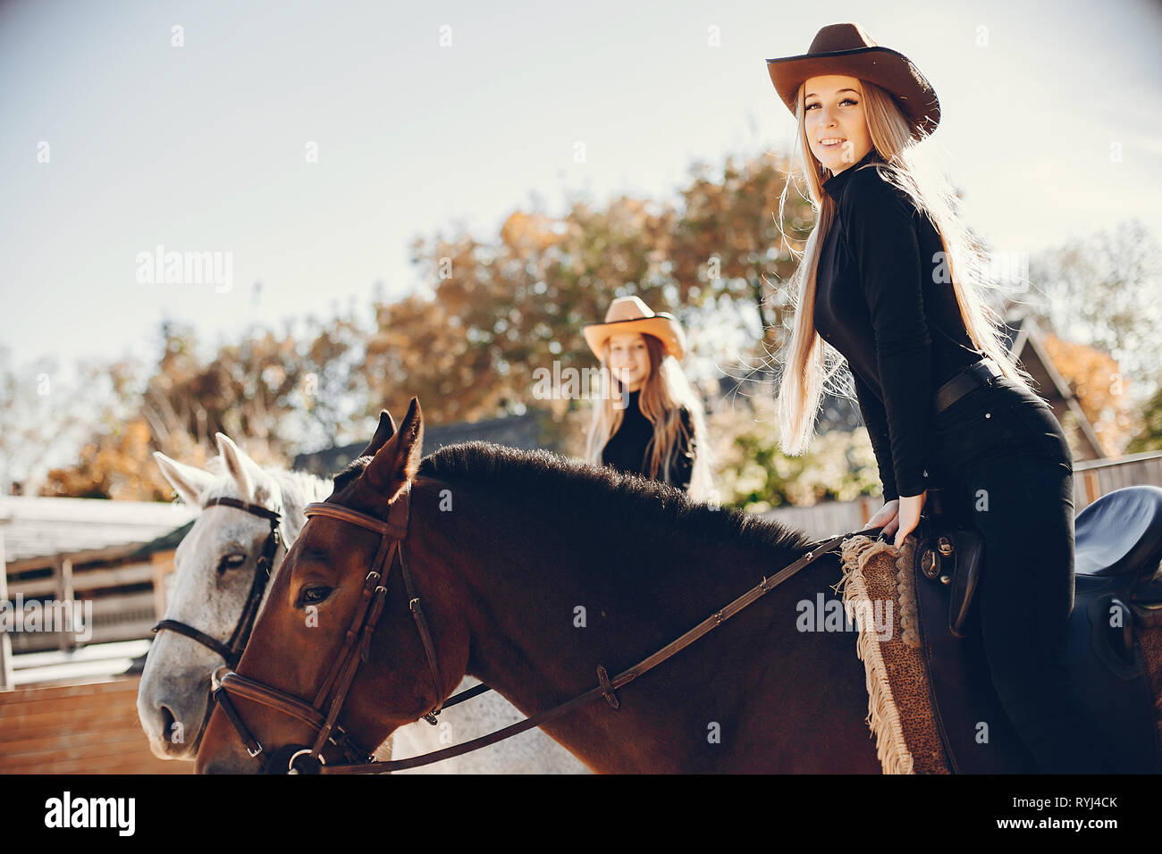 Elegant girls with a horse in a ranch Stock Photo - Alamy