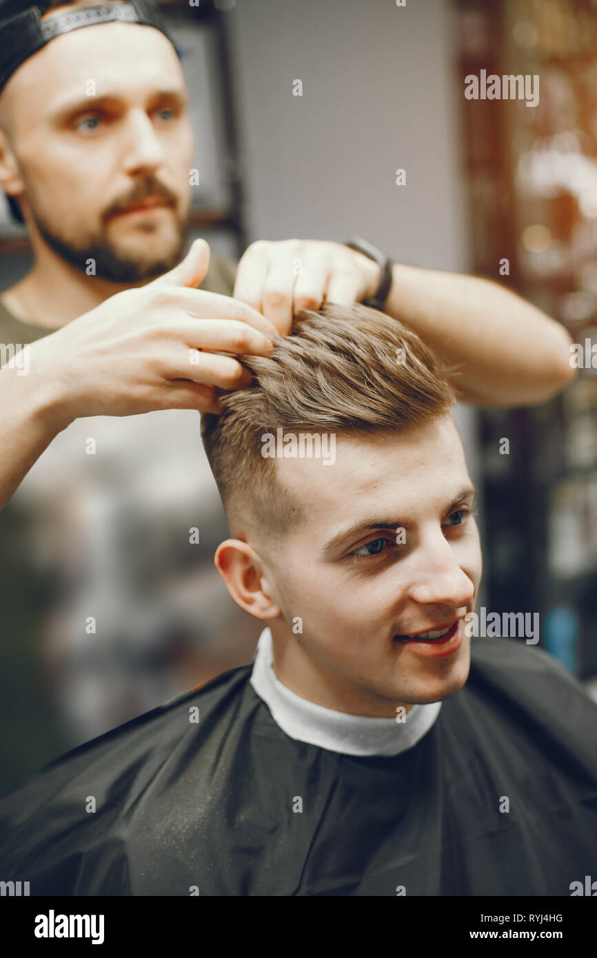 A man cuts hair in a barbershop Stock Photo - Alamy