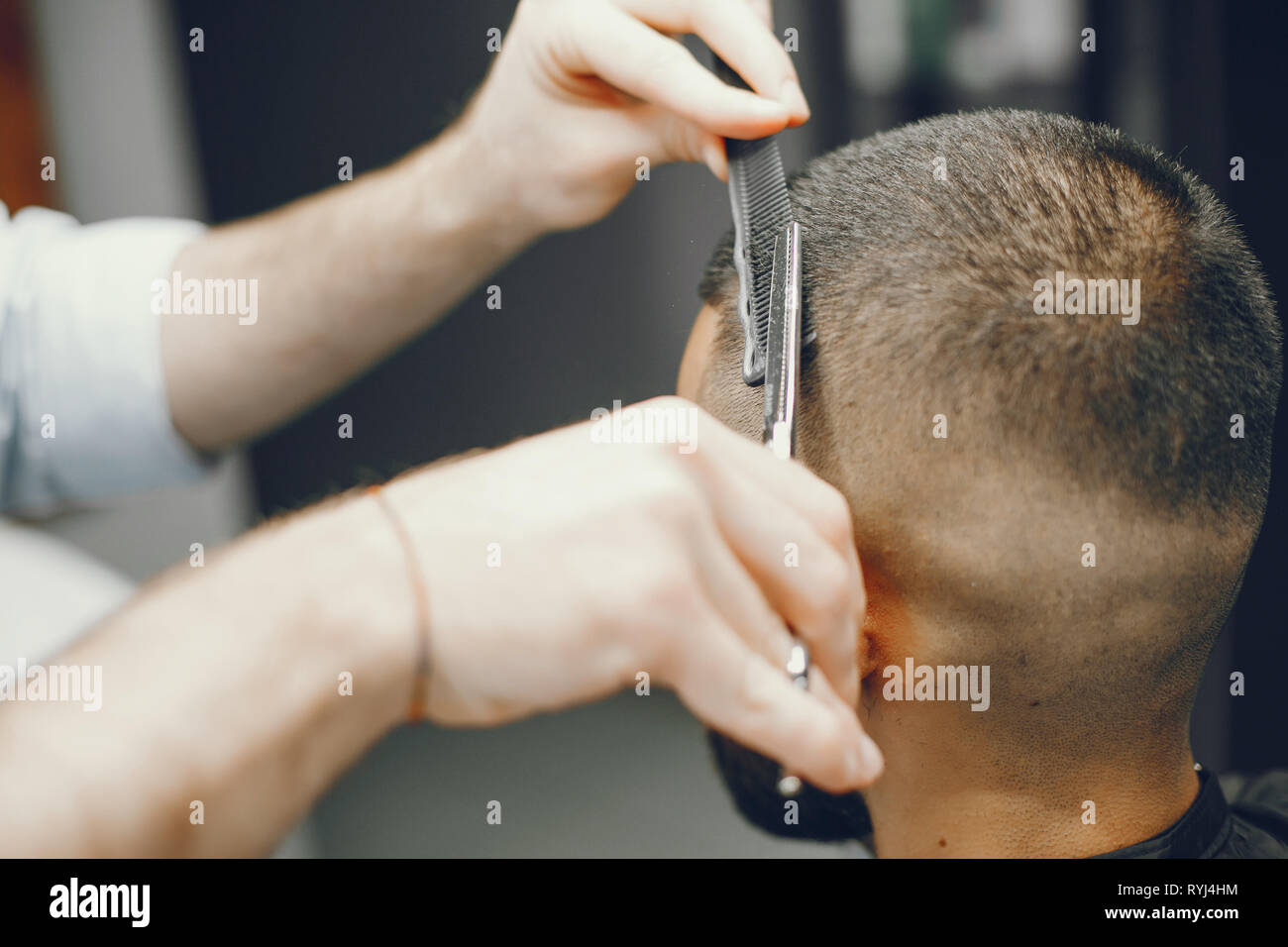 A man cuts hair in a barbershop Stock Photo - Alamy