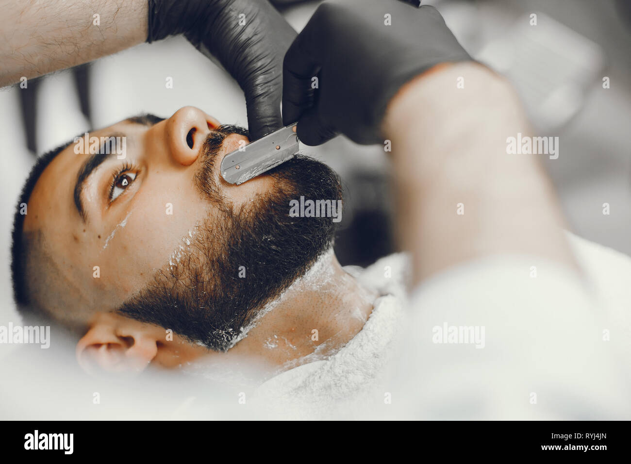 The man cuts his beard in the barbershop Stock Photo - Alamy