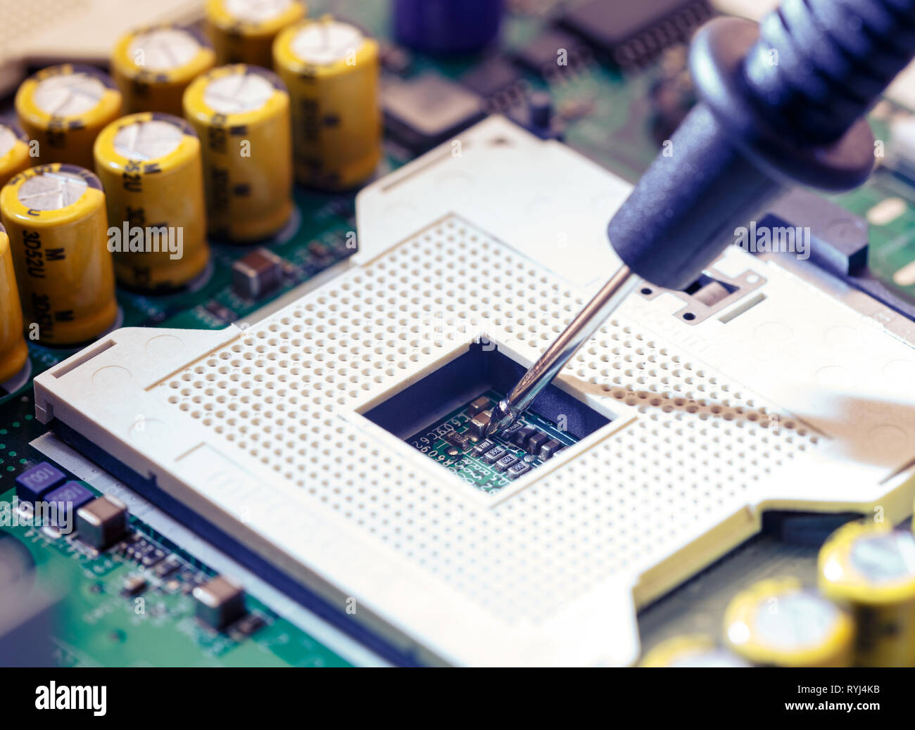 Close Up - Technician engineer measuring multimeter CPU socket computer motherboard (Technology ...