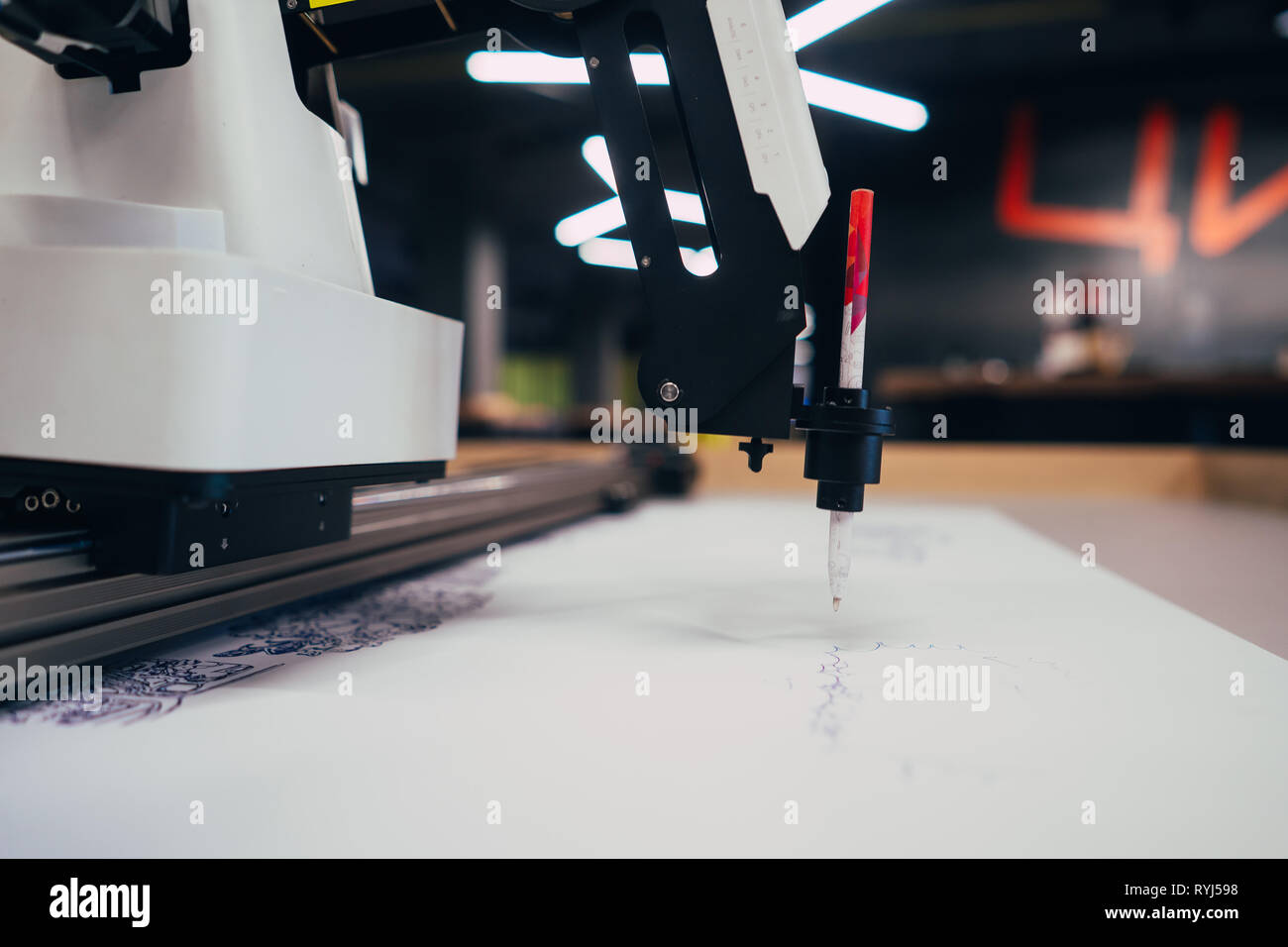 Plotter draws a pen drawing on a sheet of white paper Stock Photo - Alamy