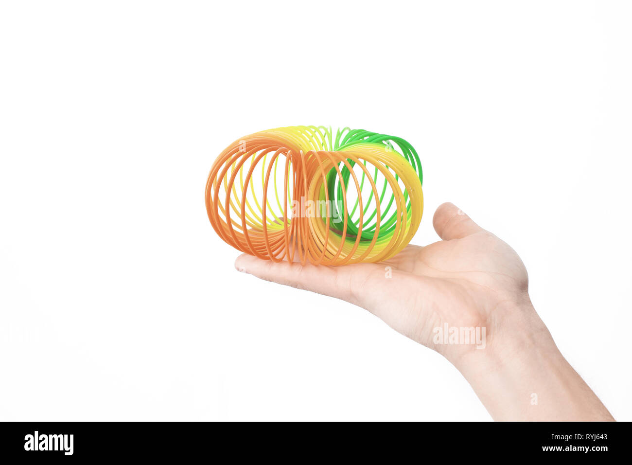 hands stretched rainbow spiral. toy from childhood Stock Photo - Alamy