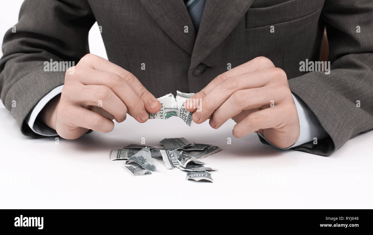 closeup.businessman tearing a dollar bill sitting behind a Desk Stock ...