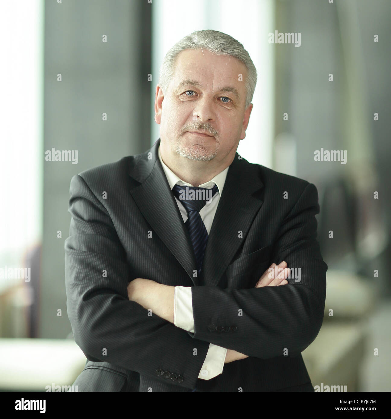 portrait of an adult businessman on office background Stock Photo - Alamy