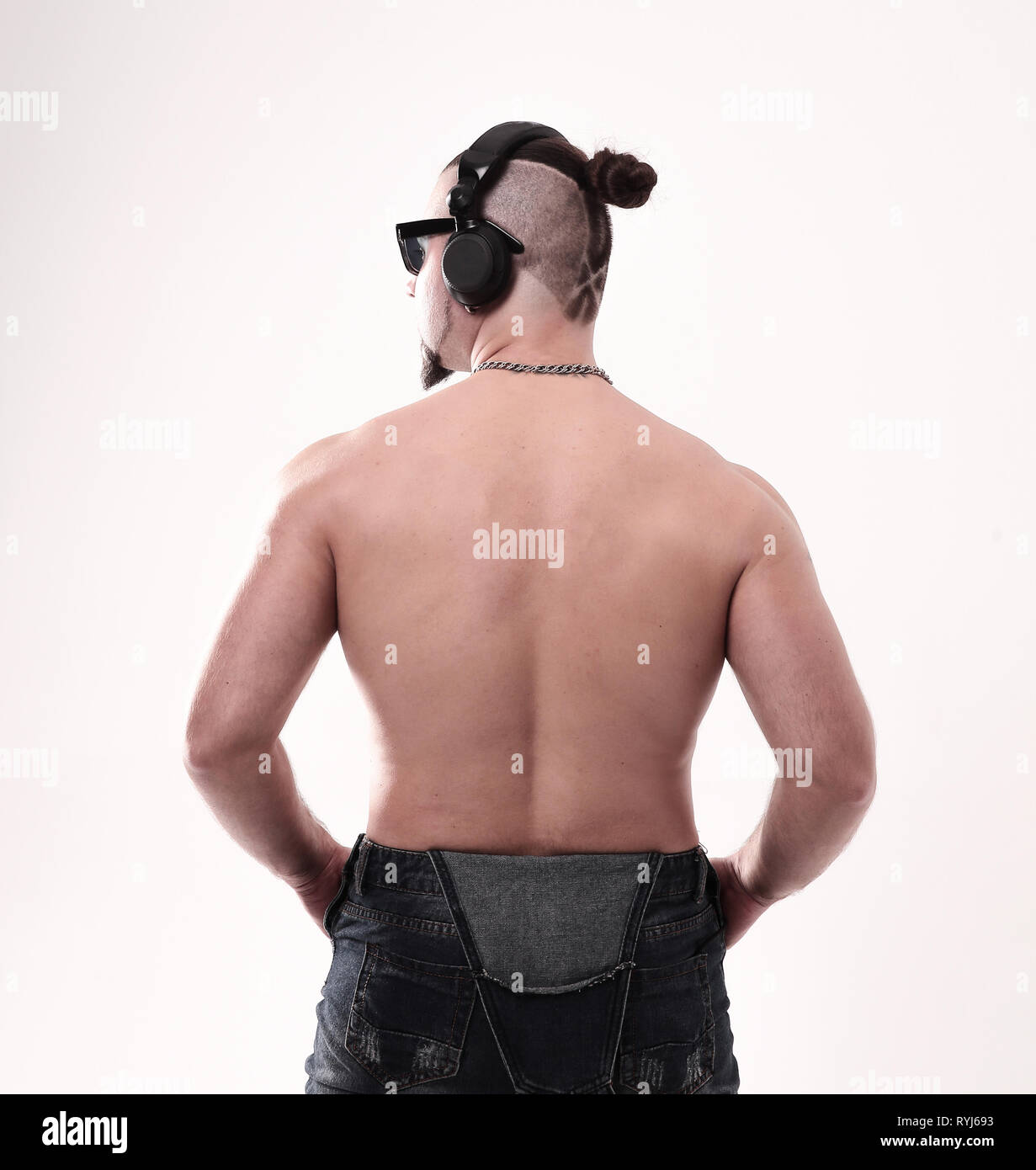 rear view.stylish man in denim overalls .isolated on white Stock Photo ...