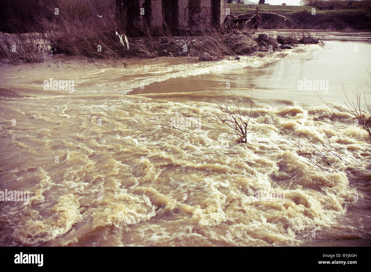 Raging waters and murky. Flooding after several days of rain Stock ...
