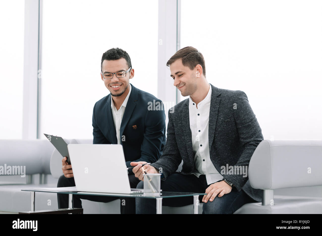 Manager and client talking in the office lobby Stock Photo - Alamy