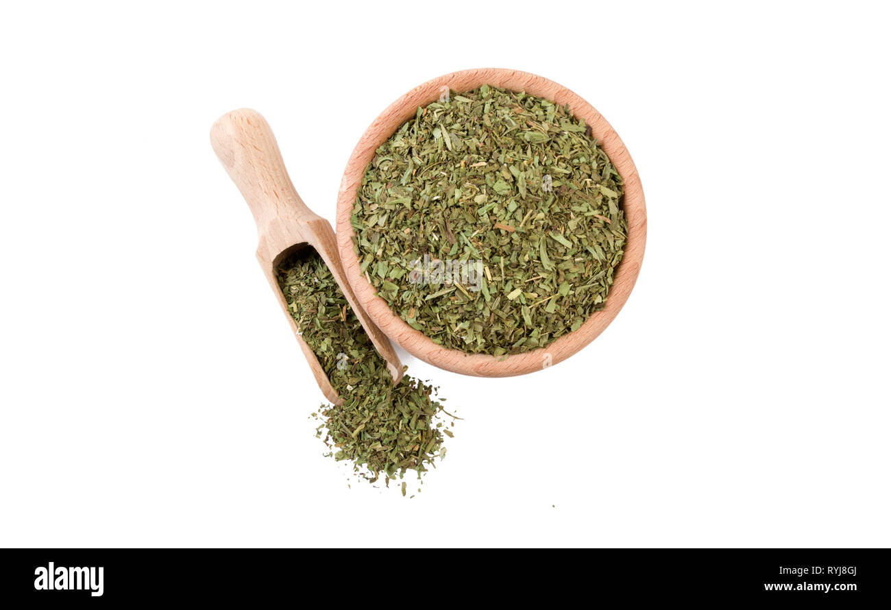 tarragon herb in wooden bowl and scoop isolated on white background ...