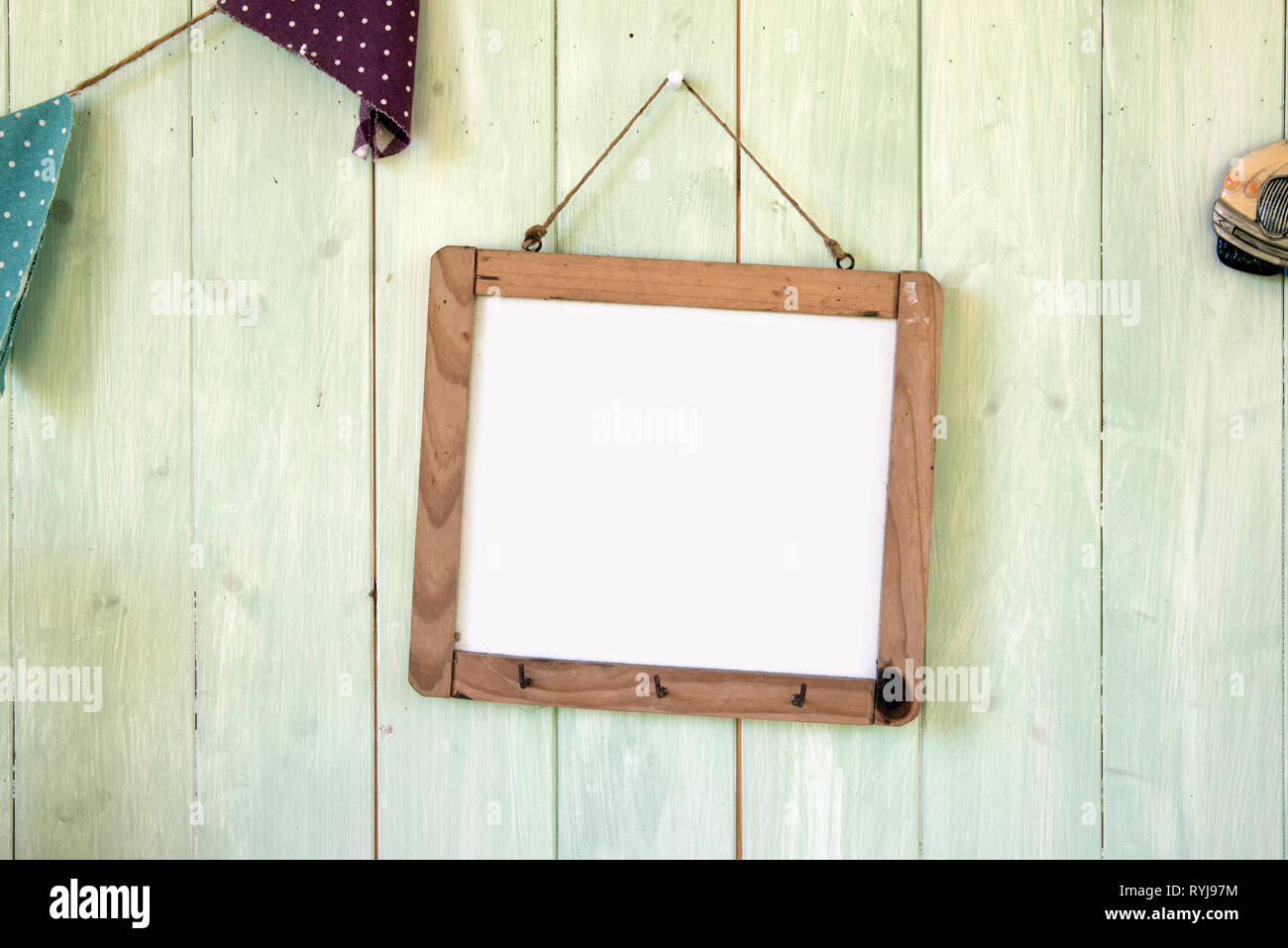 White message board hanging on retro green wooden wall background Stock ...
