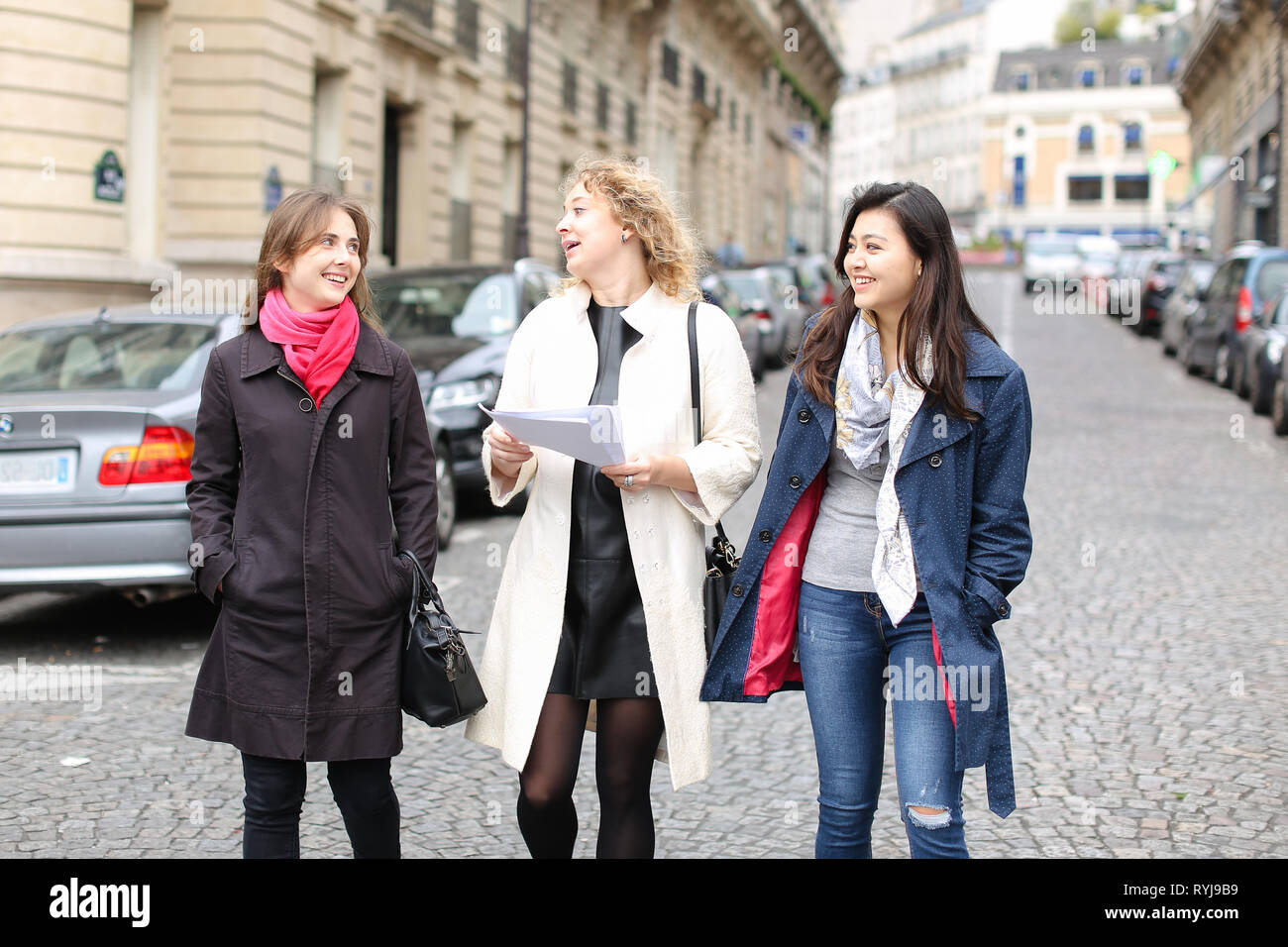 Chinese international student speaking with teacher outside in ...