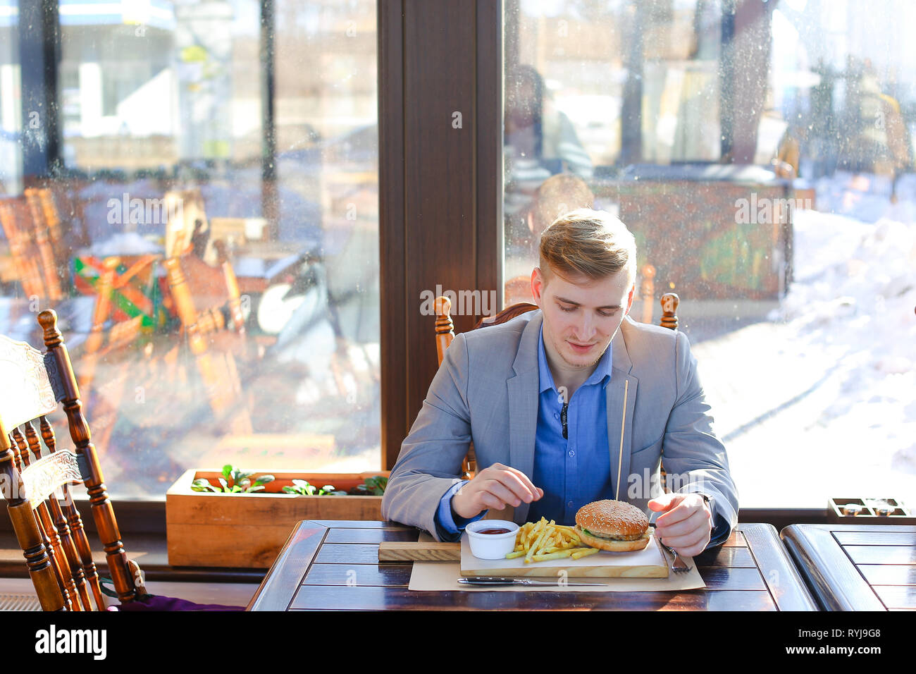 Portrait of busy young business man sitting with glass of drink and ...